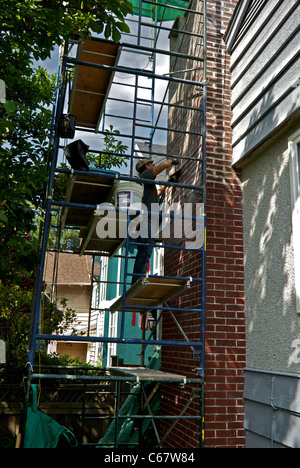 A Mason is at work on a scaffold Stock Photo - Alamy
