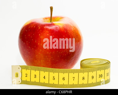 one yellow apple lies on a black old wooden table, apple on a board ...