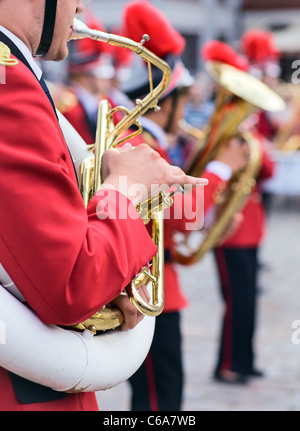 Military Band in Red Formal Attire Marching and Playing Instruments in ...