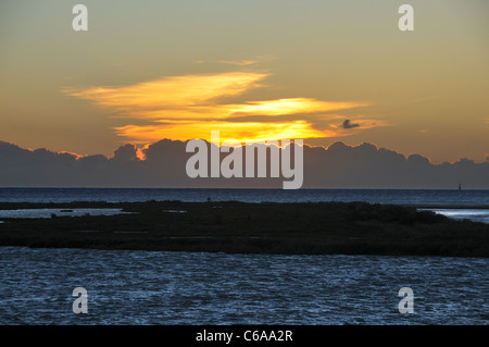 Sunrise. Ebro river at its base level, in front to the sea coast ...