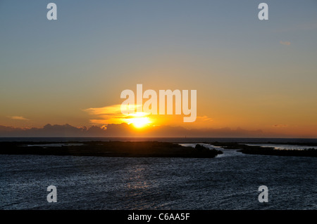 Sunrise. Ebro river at its base level, in front to the sea coast ...