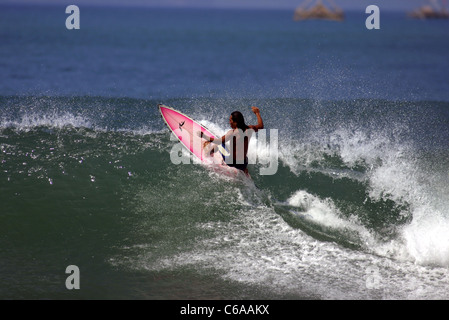 Local surfer rides a wave at Cimaja in West Java, Indonesia Stock Photo ...
