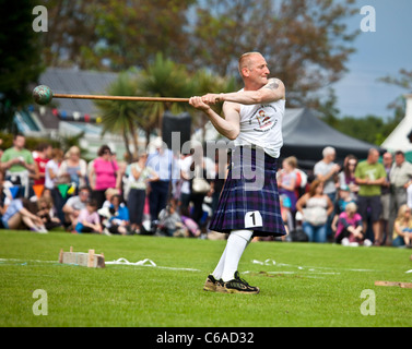 A competitor competing in the Throwing the Hammer contest during the ...
