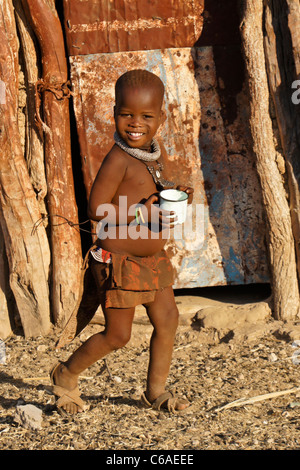 Namibia, Kaokoland. A young Himba girl in traditional attire. Her body ...