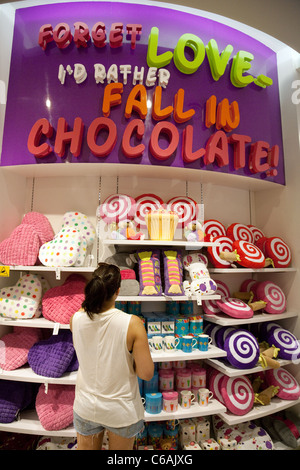 A teenage girl buying sweets in the Candylicious store, Sentosa Island ...