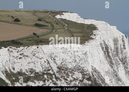 Walkers trekking along the white cliffs of Dover coastal path. Kent ...