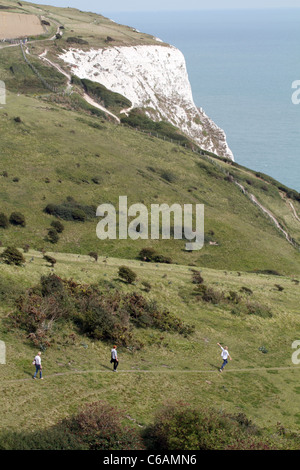 Walkers trekking along the white cliffs of Dover coastal path. Kent ...