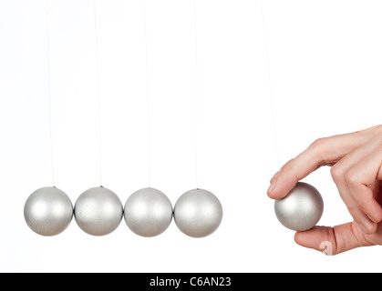 hand holding a pendulum ball Stock Photo - Alamy