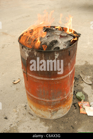 a fire in a waste paper bin or litter bin at the side of the road ...