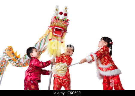 Three Chinese children playing on grass Stock Photo - Alamy