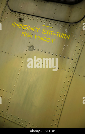 Emergency exit window on the side of a school bus above the rear wheel ...