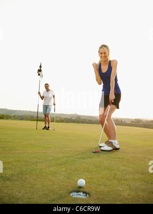 Two women cheering on golf course Stock Photo - Alamy