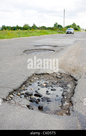 chuckhole in asphalt and rubbles in damaged road Stock Photo - Alamy