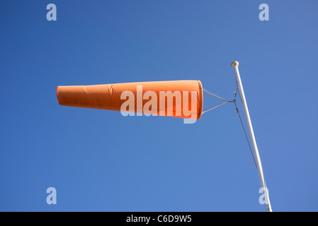 Orange safety wind sock flying at an airport Stock Photo - Alamy