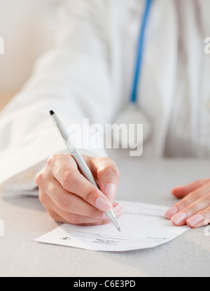 Hand of doctor writing on prescription Stock Photo - Alamy