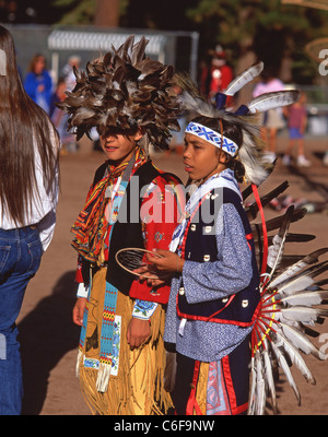A Native American dressed in a traditional outfit performs a dance at ...