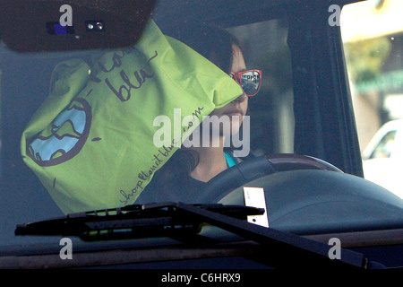 Ashley Tisdale covers her face with her shopping bag as she leaves ...