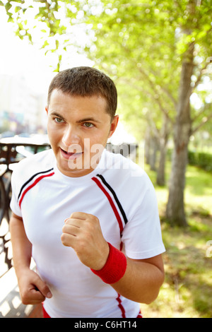 Image of handsome young guy sportsman jumping with skipping rope ...