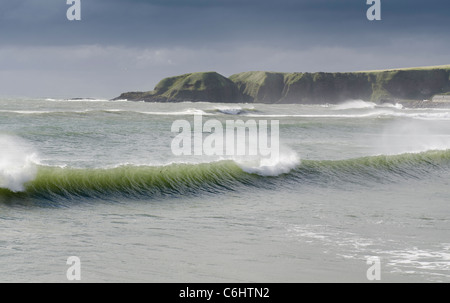 Stonehaven Bay with surf breaking on shore and dark stormy sky ...
