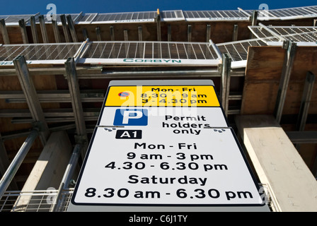 parking sign giving times and days when parking is not restricted to ...