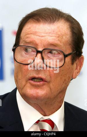 British actor Sir Roger Moore and his wife Kristina Tholstrup pose for ...