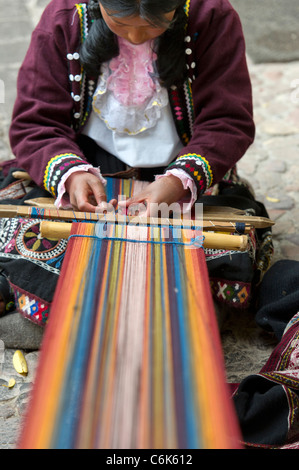 Front view of Hispanic woman weaving a basket with esparto fibers ...