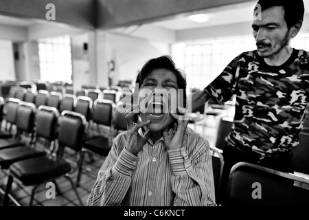 A Mexican woman screams intensively during the exorcism rite performed ...