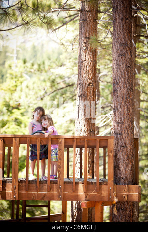 Girl climbing in treehouse outdoors Stock Photo - Alamy