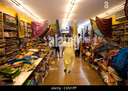 A Woman buying saris in a shop in the Kinari market, "Old Delhi" India ...