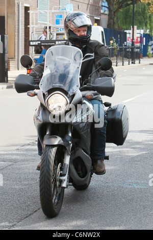Adrian Chiles Arrives by motorcycle for a photo shoot at a studio in ...