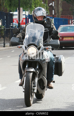 Adrian Chiles Arrives by motorcycle for a photo shoot at a studio in ...
