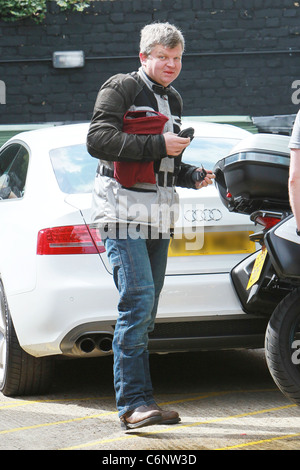 Adrian Chiles Arrives by motorcycle for a photo shoot at a studio in ...