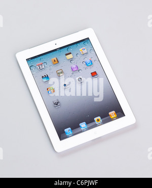 White Apple iPad 2 tablet computer with desktop icons on its display ...