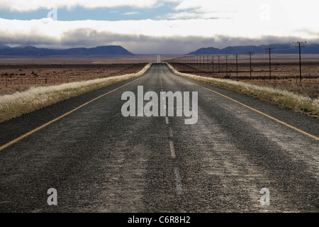 Scenic landscape with tar road and motorcycle Stock Photo - Alamy