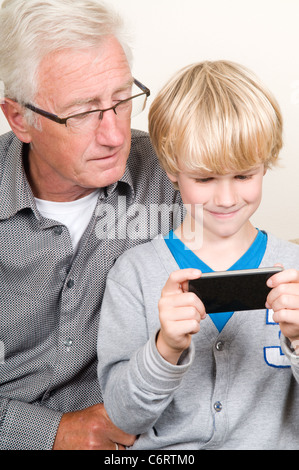 This kid learns his grandpa to use a smartphone Stock Photo - Alamy