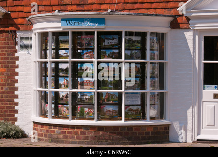 The front or exterior of an English estate agents with an estate agent ...