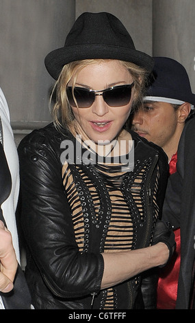 Madonna is escorted out of Aura nightclub by her personal bodyguard ...