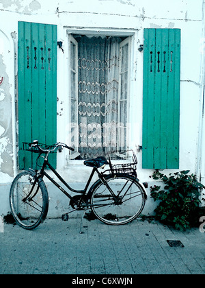 Bicycle propped up by window of old coaching inn Stock Photo - Alamy