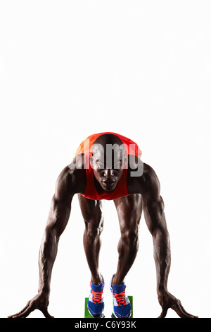 Runner crouched at starting line Stock Photo - Alamy