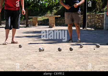 Men playing French game of Petanque outside the Saint Nicolas Priory at ...