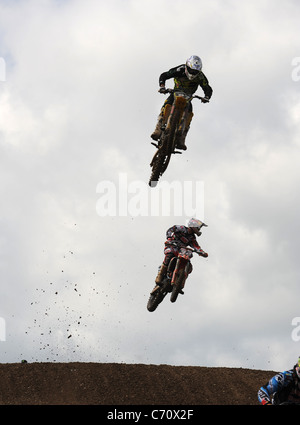 Motocross Racers jump through the air on MX Bikes Stock Photo - Alamy