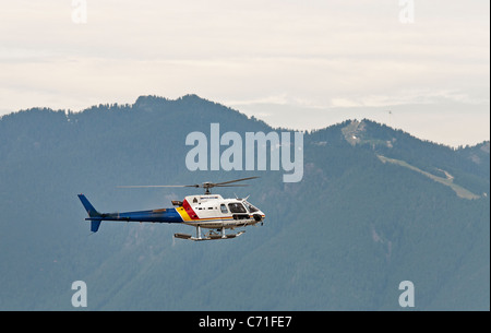 A Royal Canadian Mounted Police helicopter, a Eurocopter AS350, flies ...