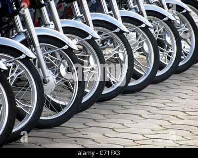 A row of front wheels all lined up on the prom in Aberystwyth Stock ...