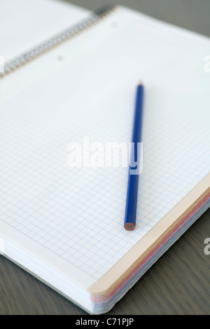 Blank notebook and pencil on color background Stock Photo - Alamy