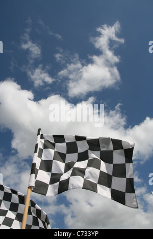 grand prix chequered flags flying in wind and blue sky Stock Photo - Alamy