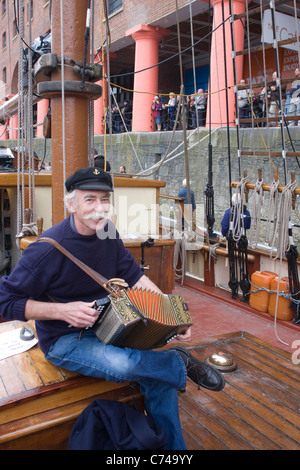 Musician playing accordion and singing sea shanties on traditional ...