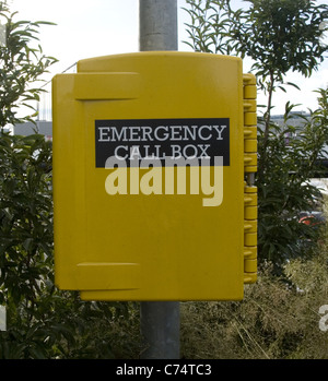 Public emergency call box phone with red fire department and blue ...