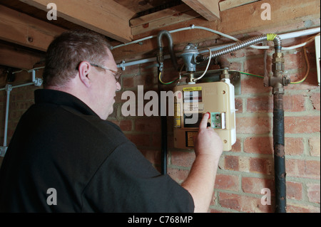 man using a quantum key prepayment electric meter, paying for ...