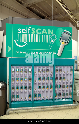 A French supermarket self scan collection point with portable devices ...