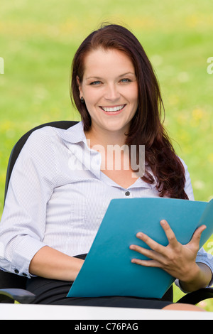 attractive business woman holding a table Stock Photo - Alamy